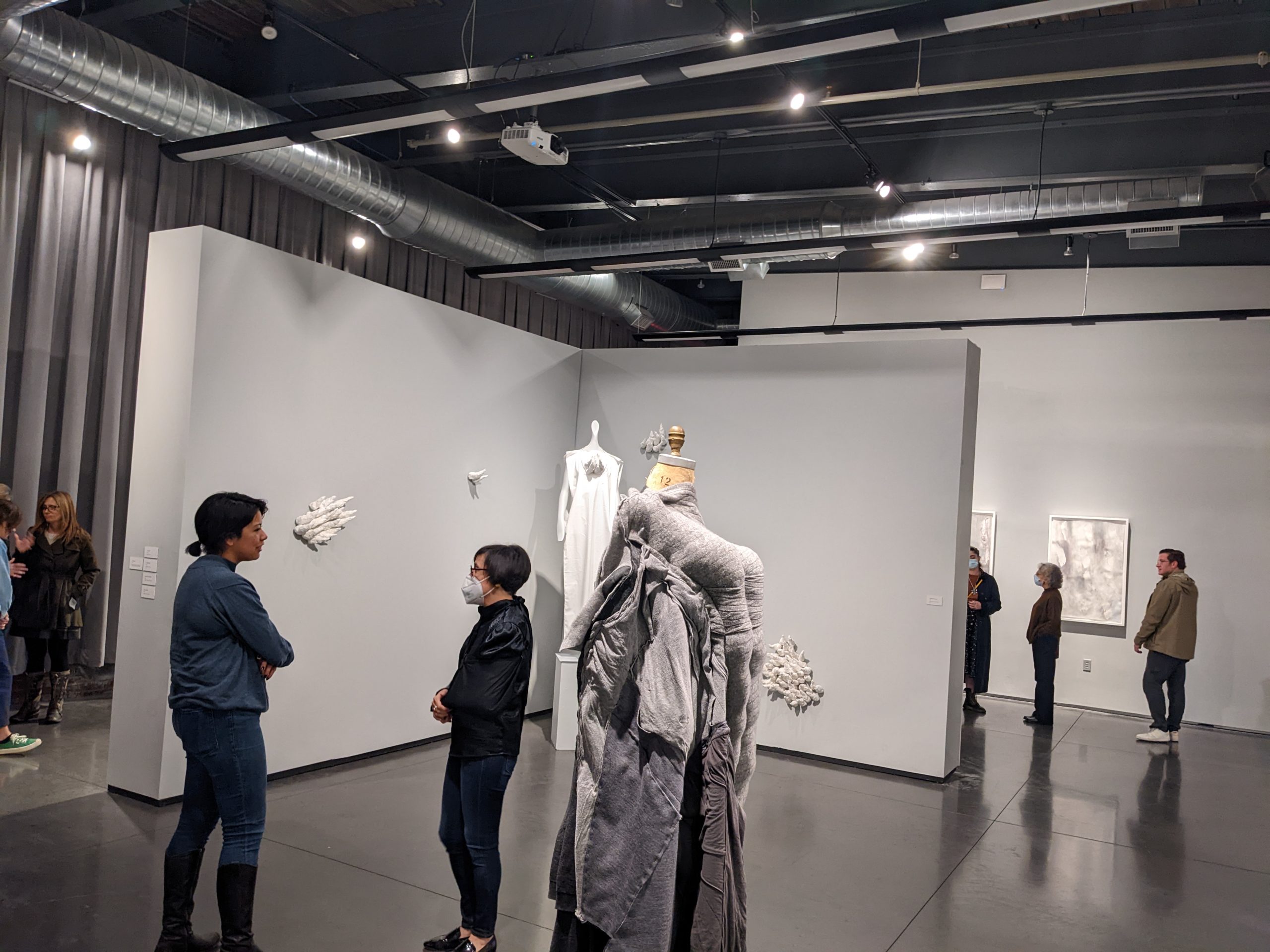 Taleen Batalian (center) speaking to an admirer at the exhibit opening ...